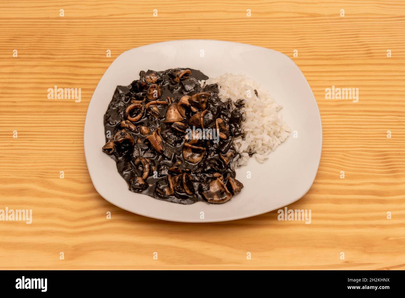 Typical recipe from the north of Spain with squid with ink sauce and ...
