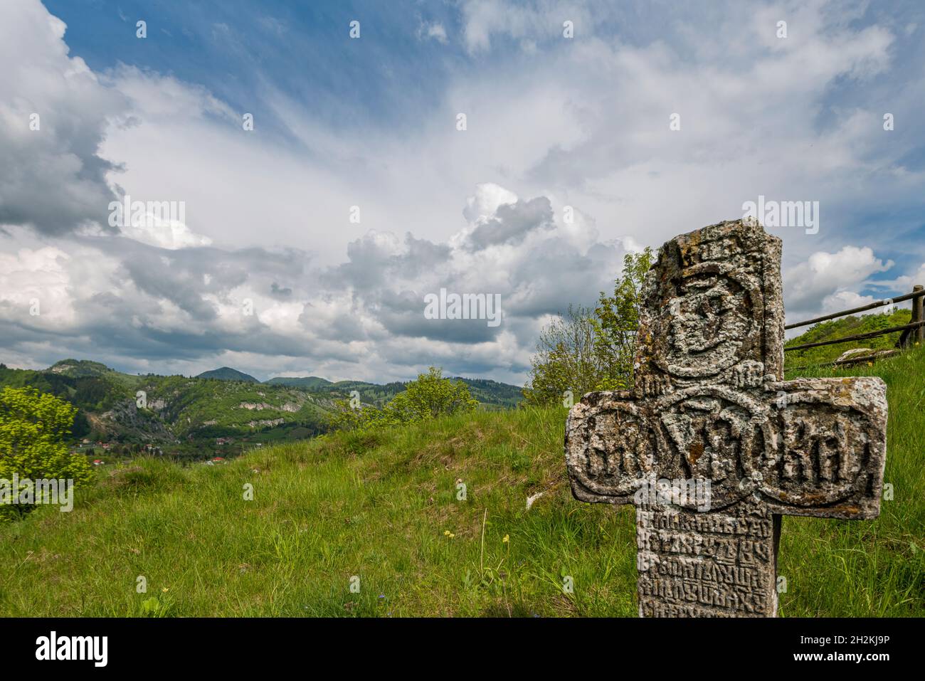 Stone cross with symbols in the middle of a field in the romanian ...