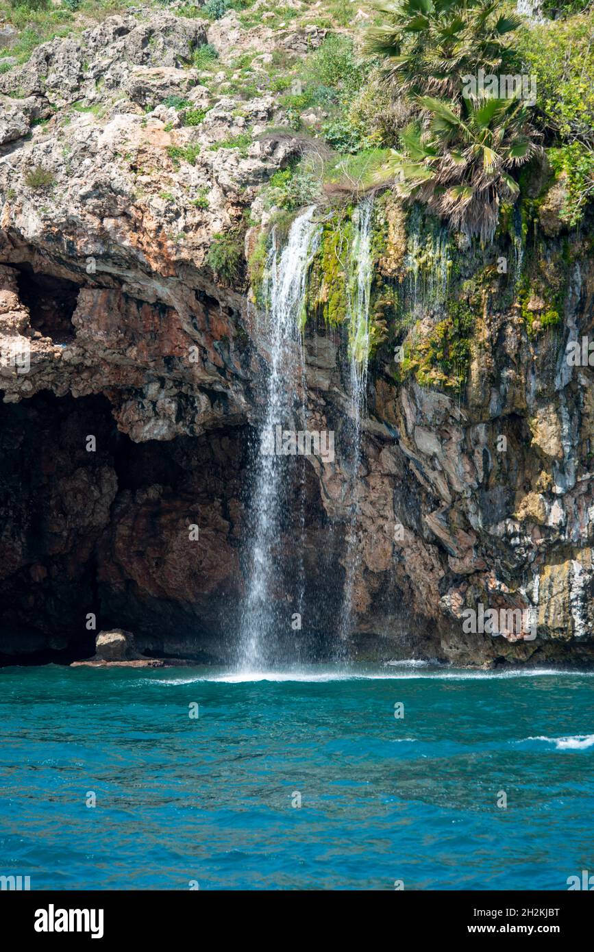 Freshwater waterfall falling on the shores of the Mediterranean between ...