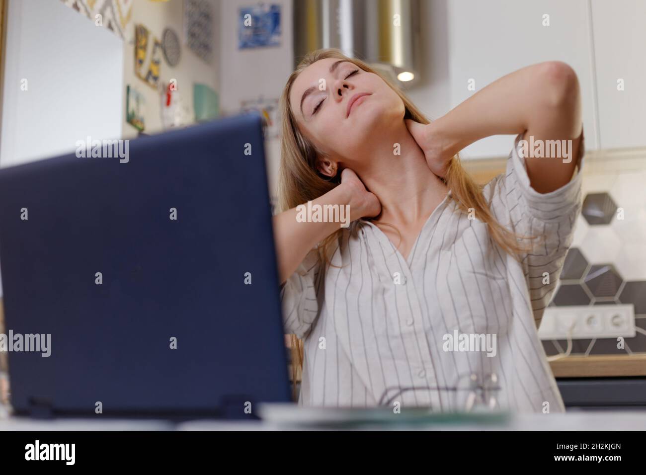 Woman working on pc laptop suffering from neck pain, osteochondrosis ...