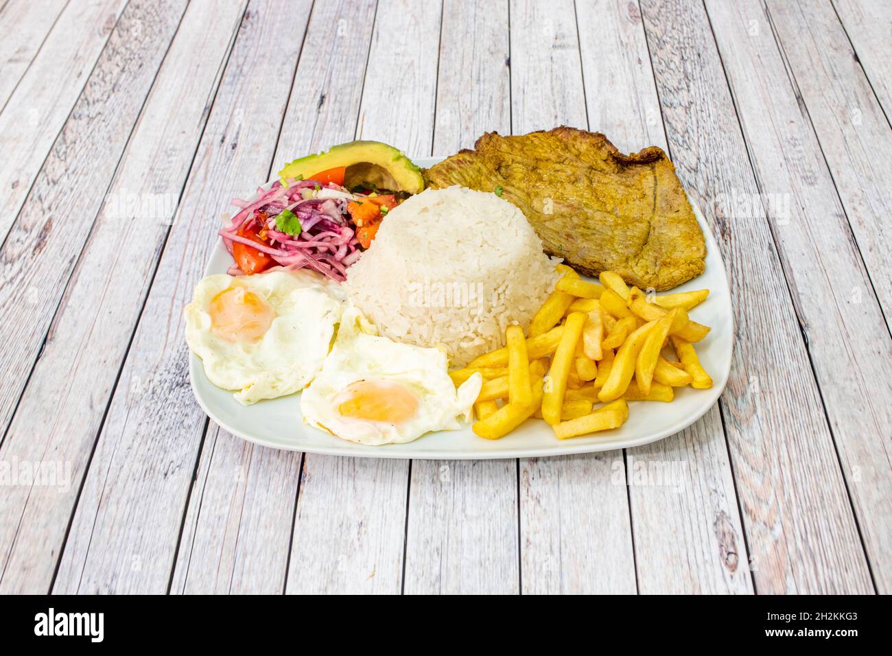 Dish of traditional churrasco from ecuador beef fillet with fried eggs ...