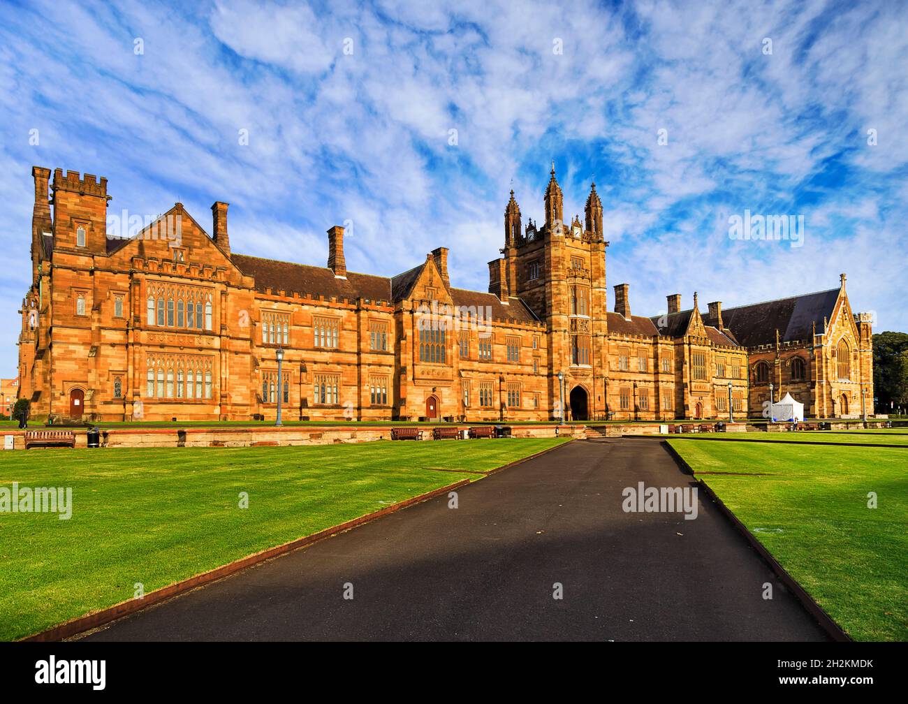 Asphalt walkway to the entrance of historic building of high-school ...