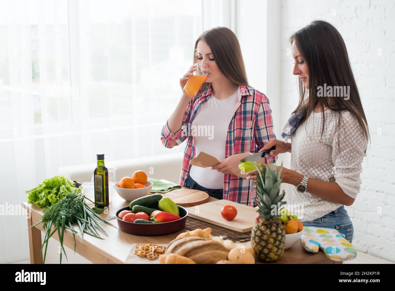 Gorgeous young Women preparing dinner in a kitchen concept cooking ...