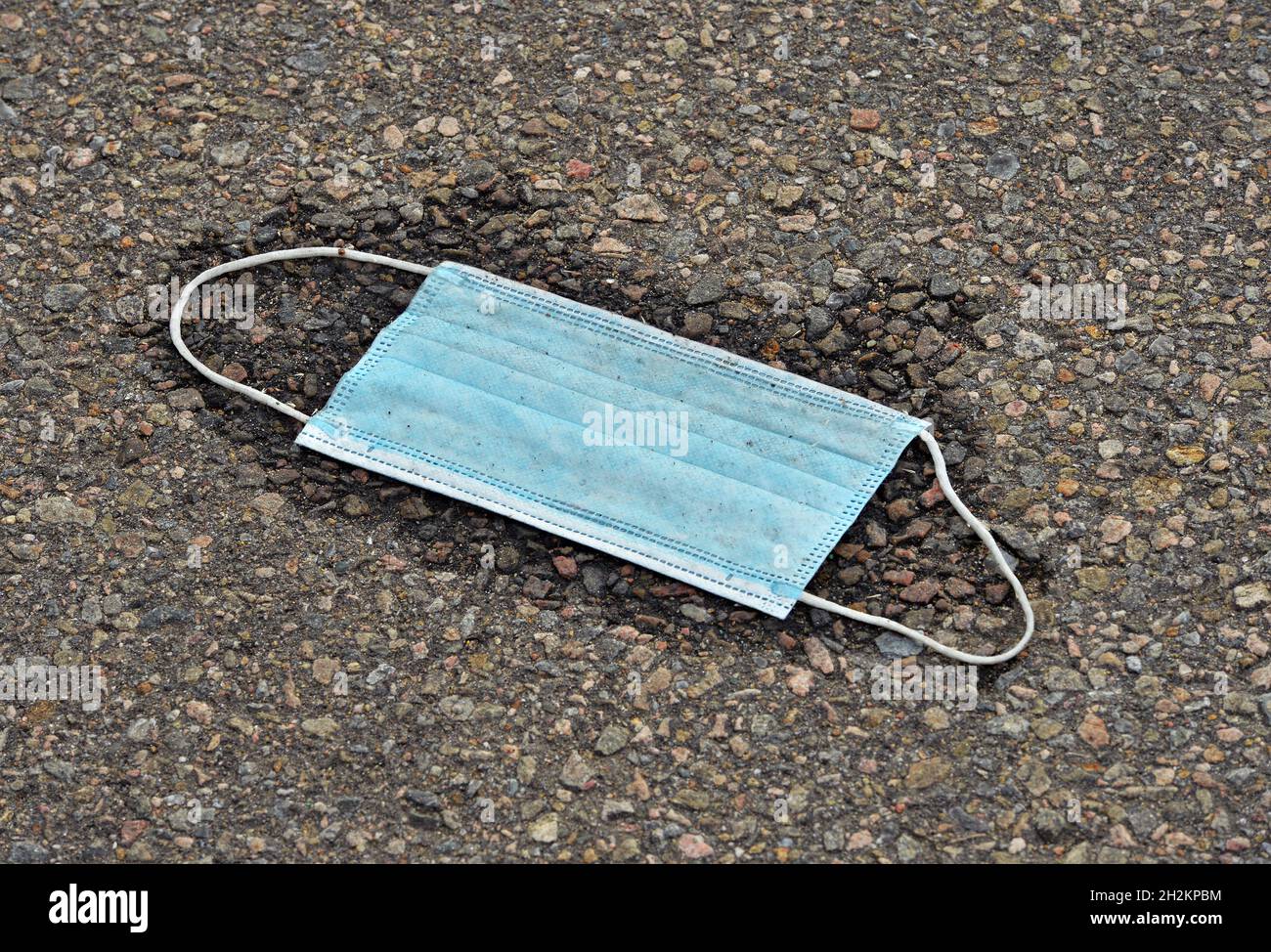 face mask on the ground Stock Photo - Alamy