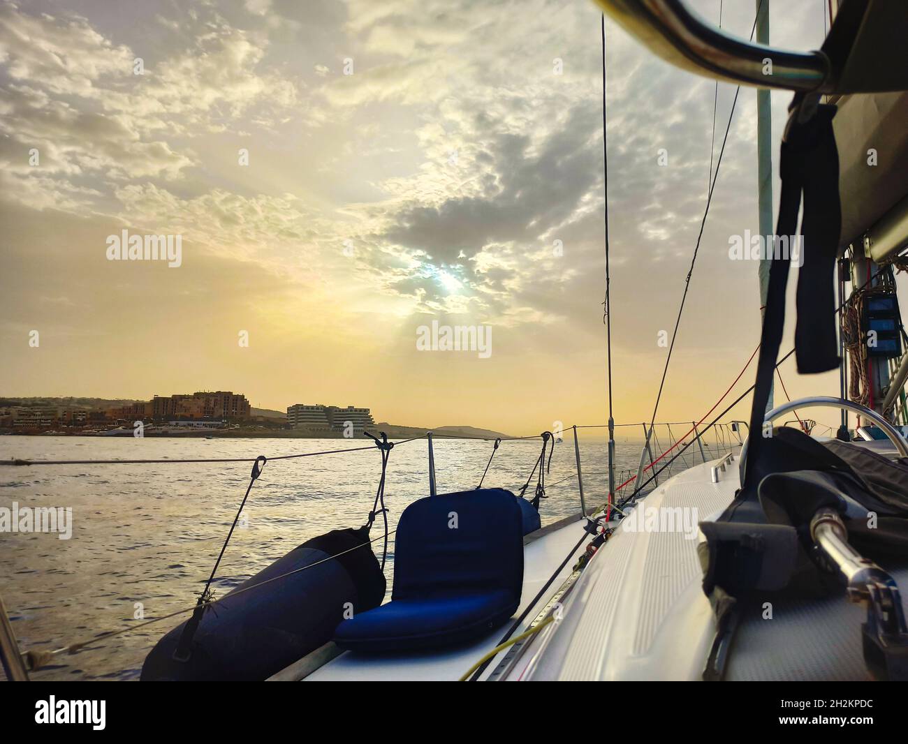 Beautiful sunset from aboard a luxury yacht sailing off the coast in ...