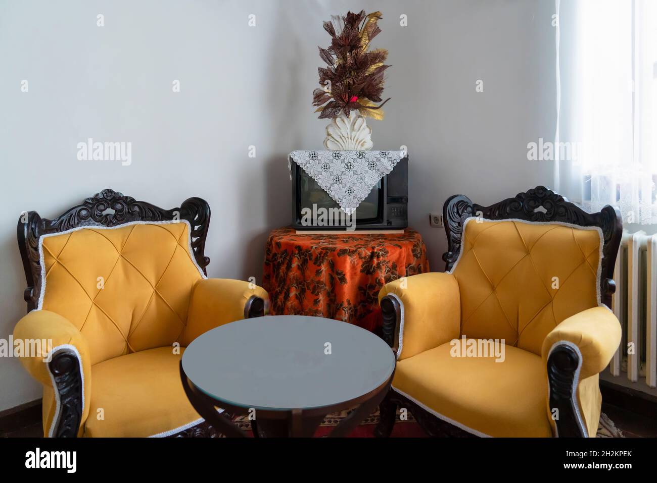 Turkish sitting room with retro furniture and television. Selective ...