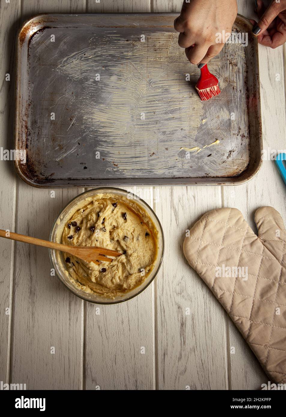 The process of spreading baking tray with butter for making chocolate ...