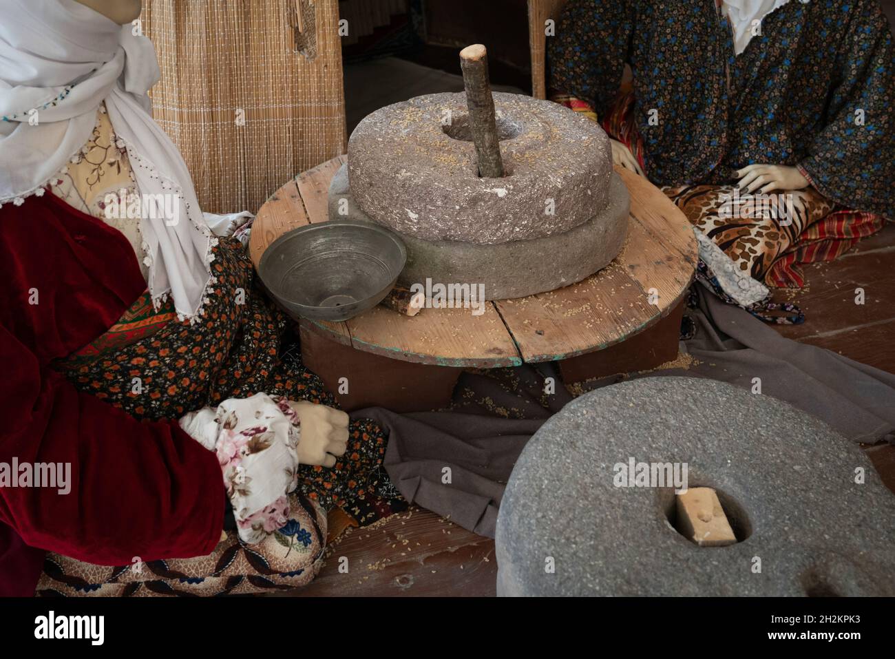 An ancient hand mill made of stones and wood. Flour grinding device ...
