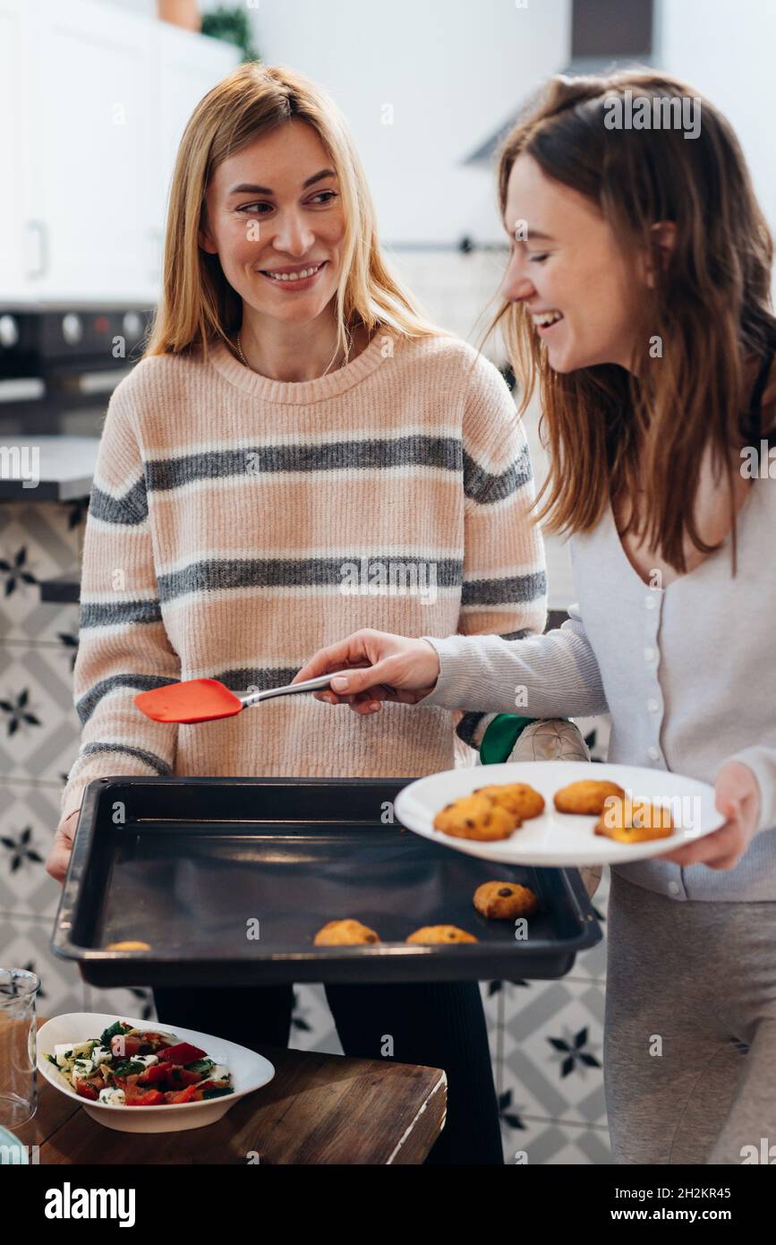 Female friends in the kitchen baked cookies Stock Photo - Alamy