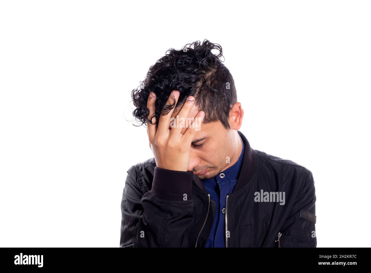 Disappointed man with his hand on his face. White background ...