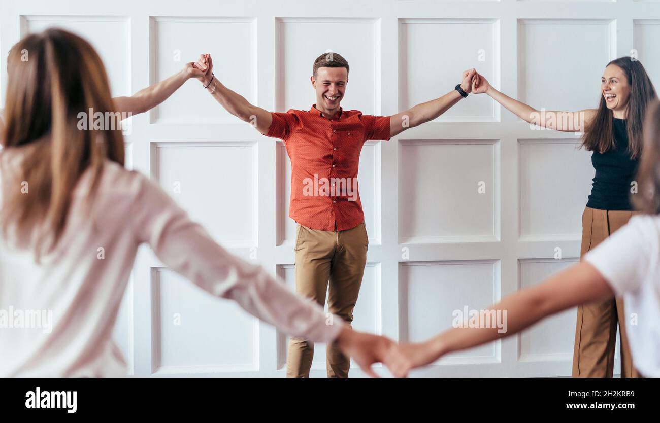 People hold hands, play and have fun Stock Photo - Alamy
