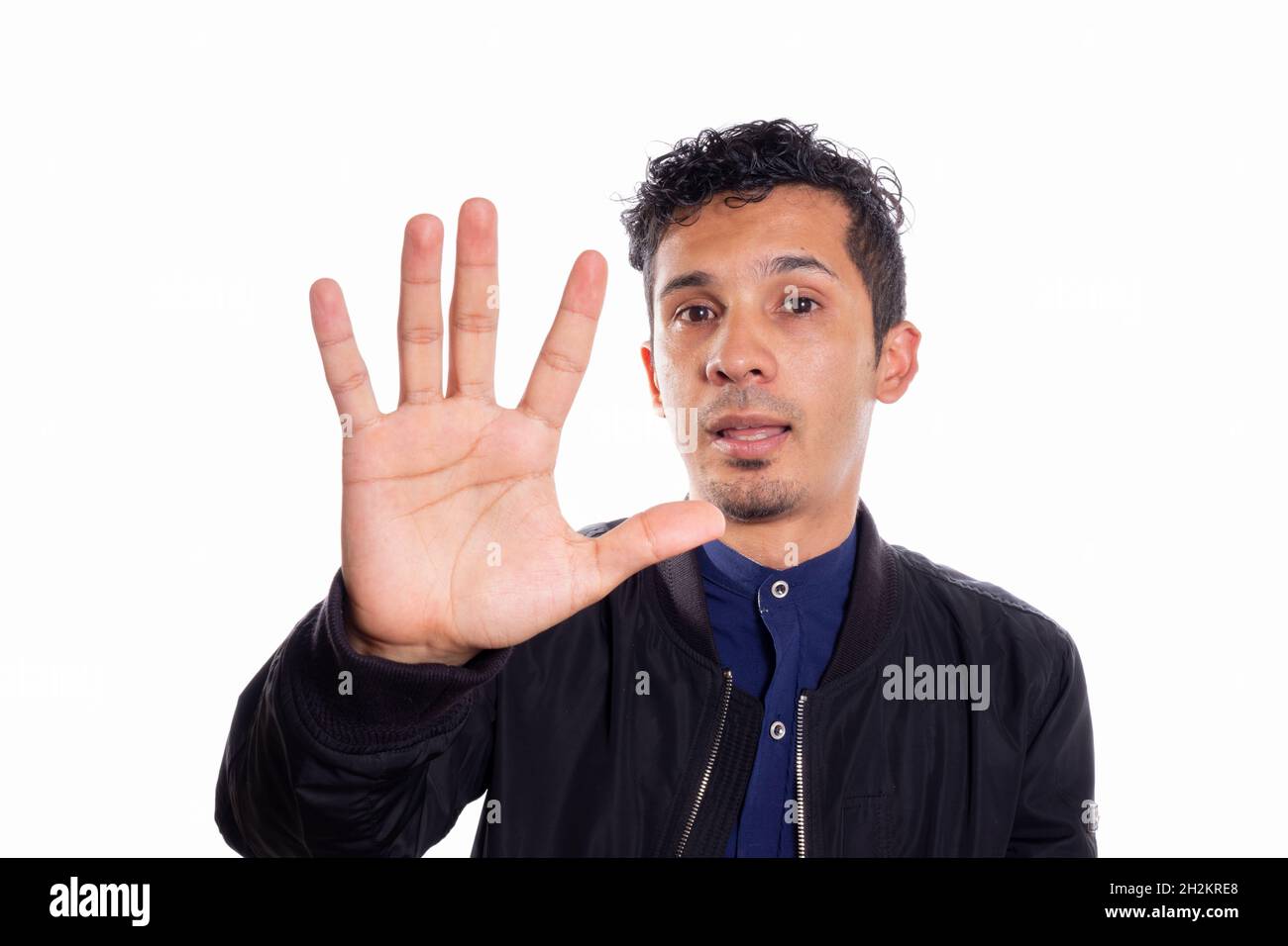 Young adult indicating to stop with hand. White background. Please stop ...