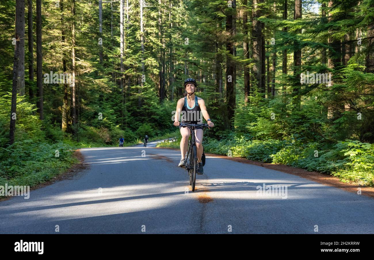 Adventurous Woman Bike Riding on a Trail in Forest Stock Photo - Alamy