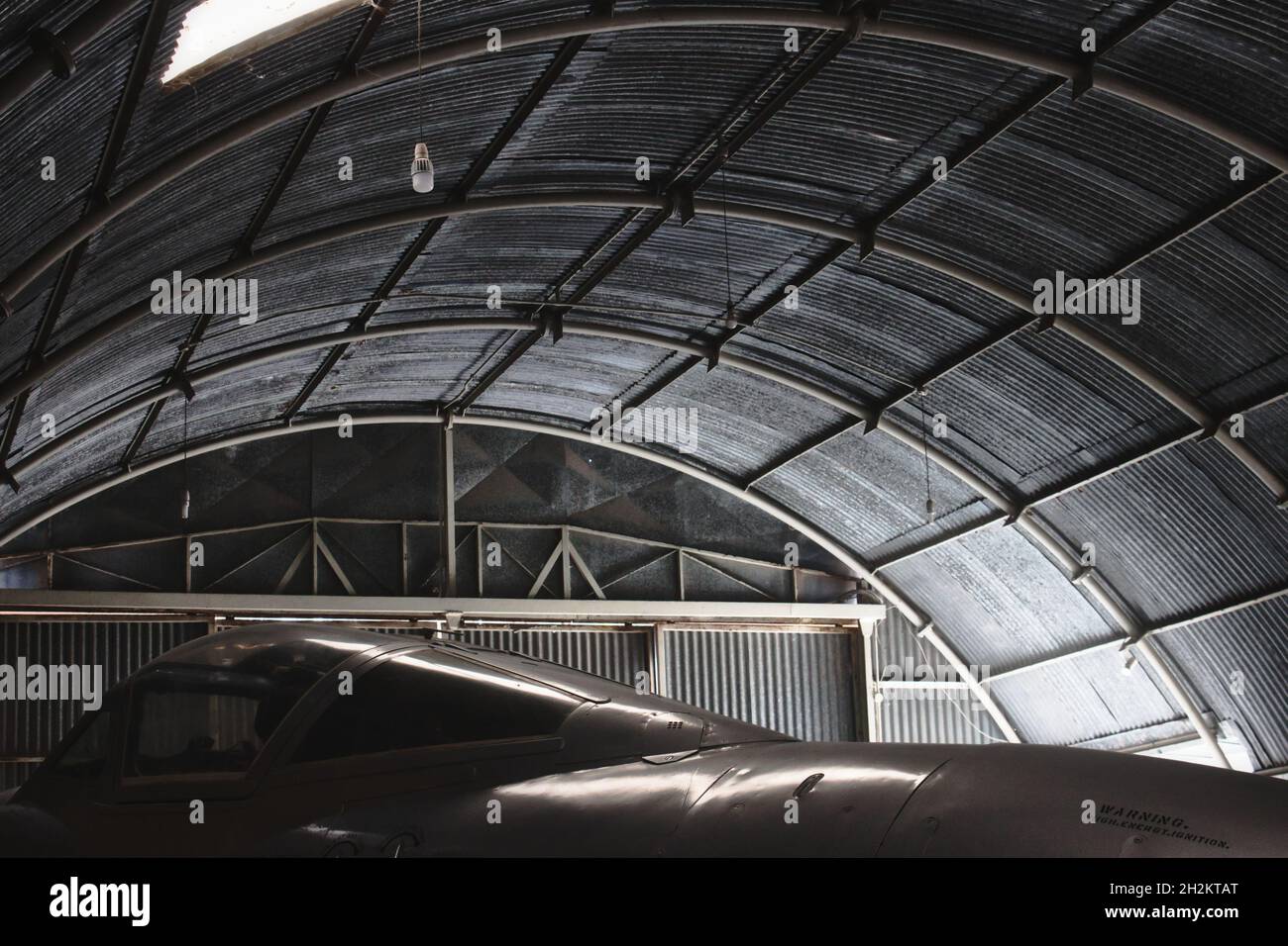 Moody shot of a fighter jet aircraft in a big aviation hanger Stock ...