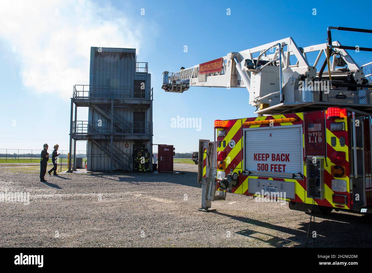 A fire truck extends its ladder during a training event held by the ...