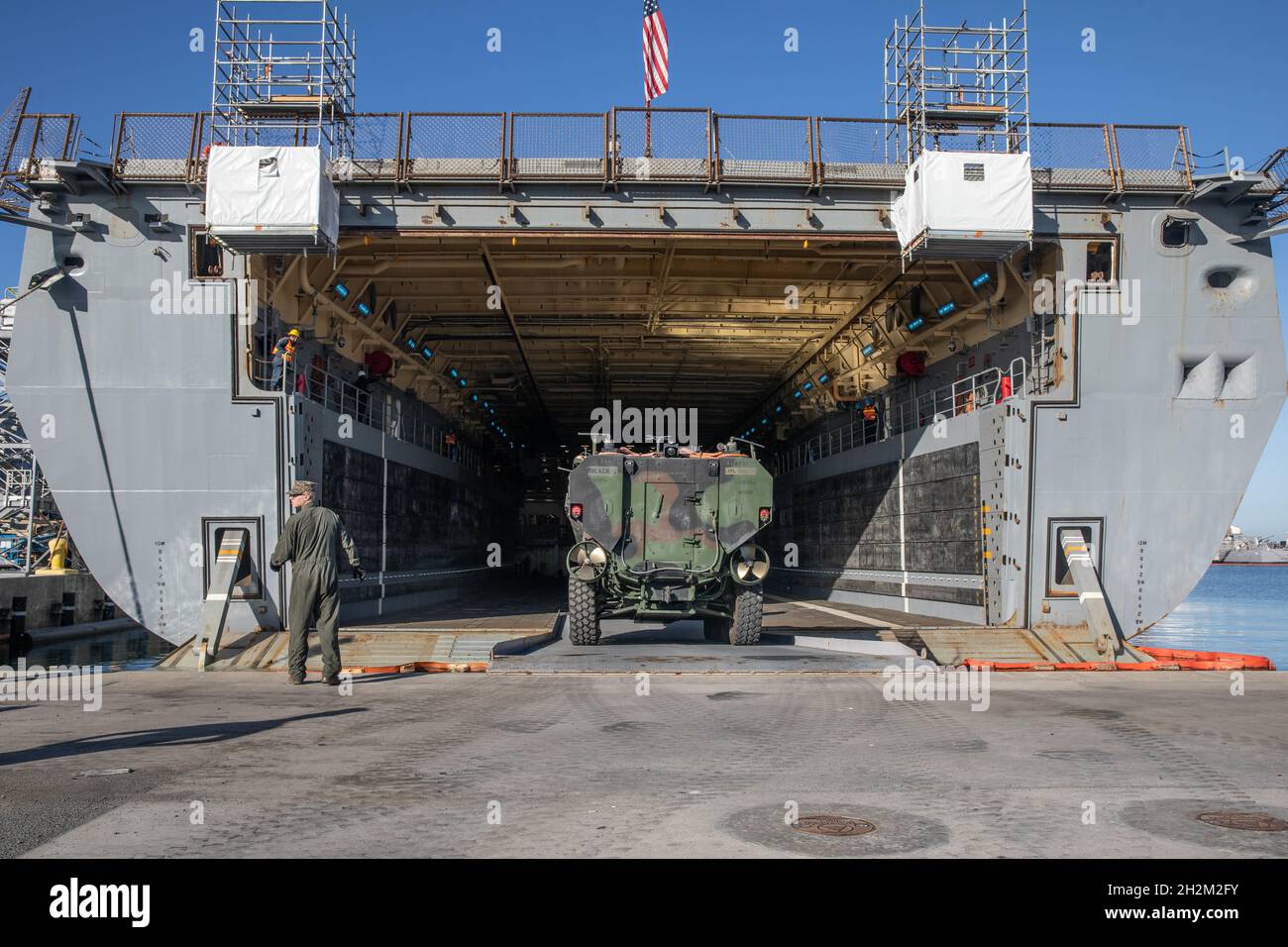 U.S. Marines and Sailors load an amphibious combat vehicle (ACV), with ...