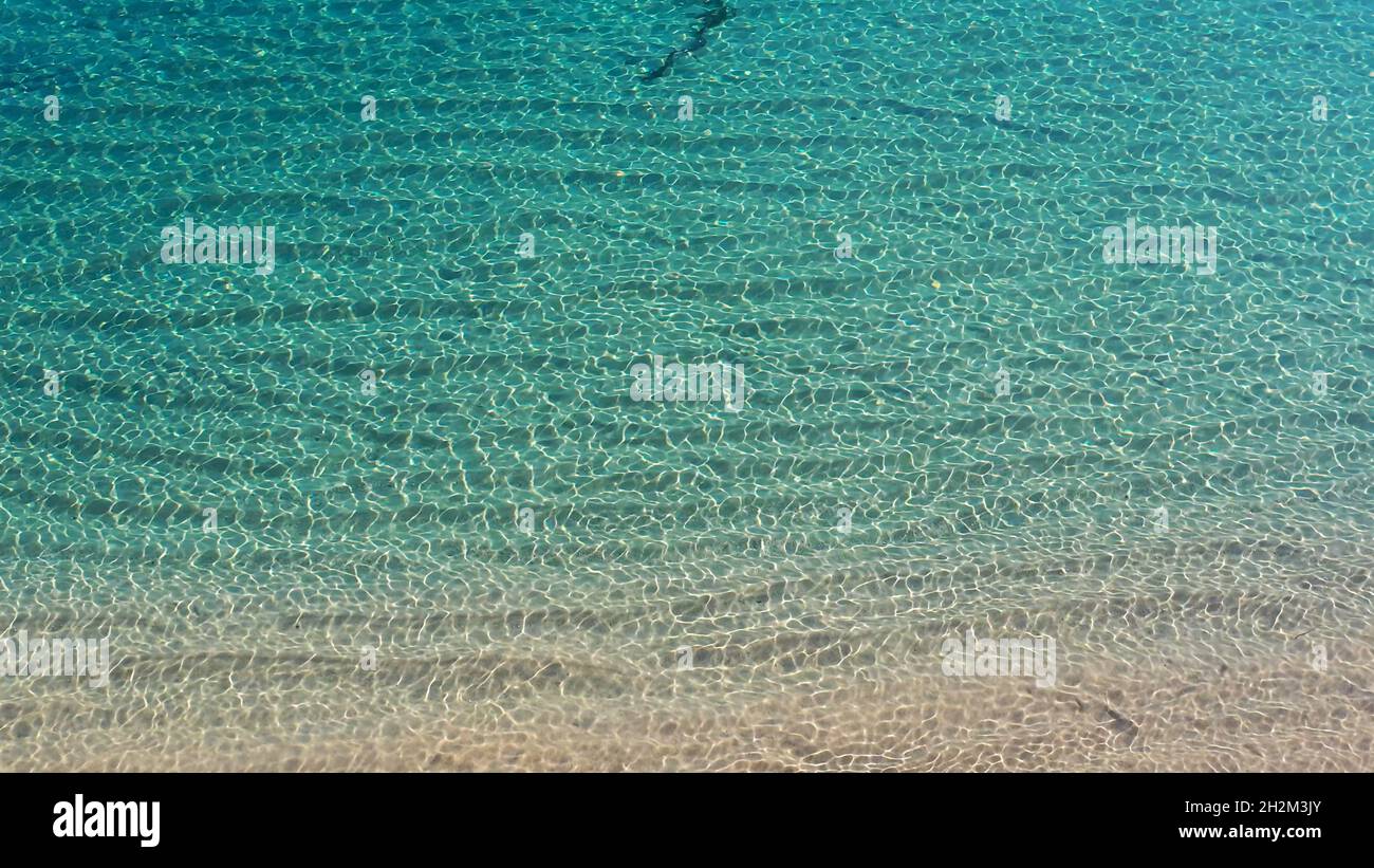 Aerial view of the ocean surface with clear water and a view of the ...