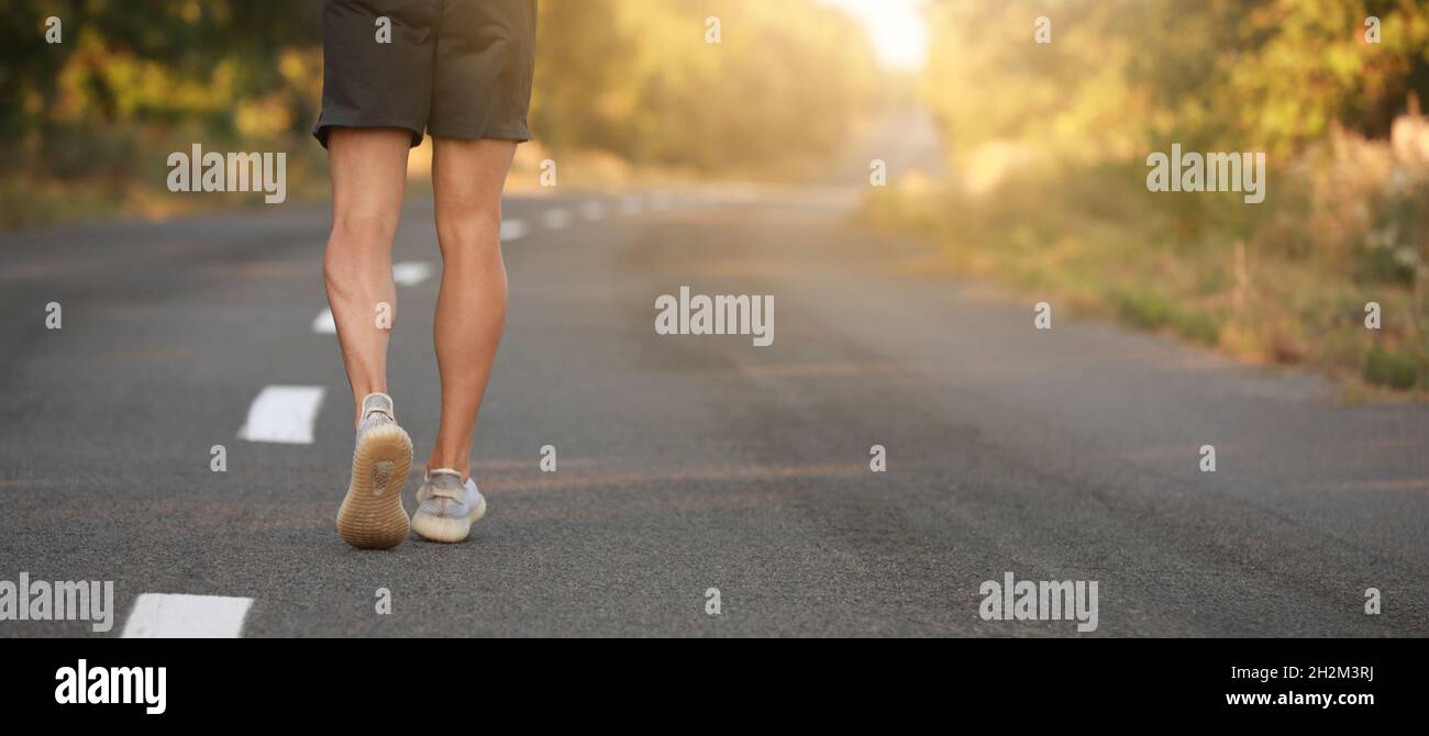 Sporty young man running outdoors Stock Photo - Alamy