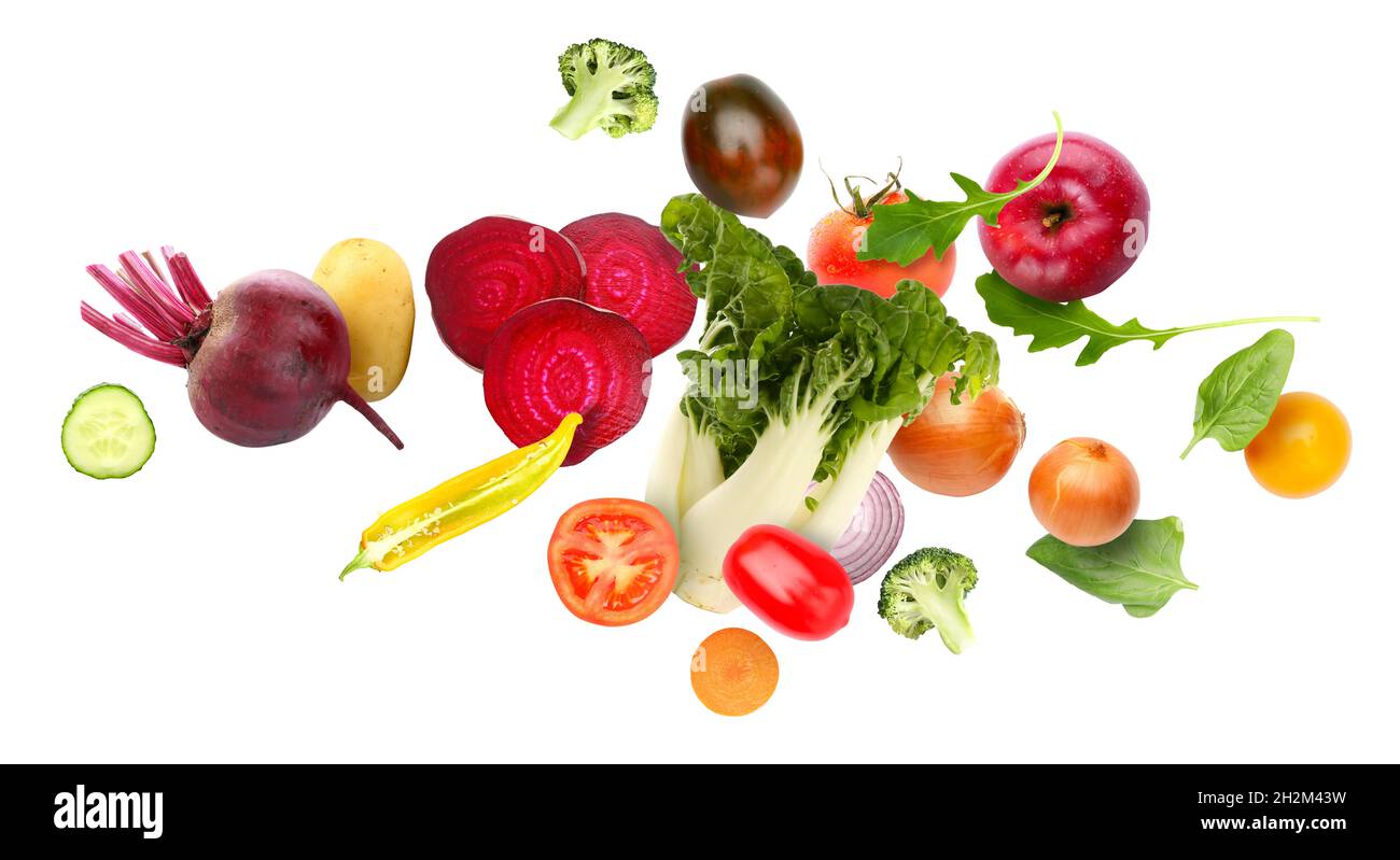 Flying fresh vegetables on white background Stock Photo - Alamy