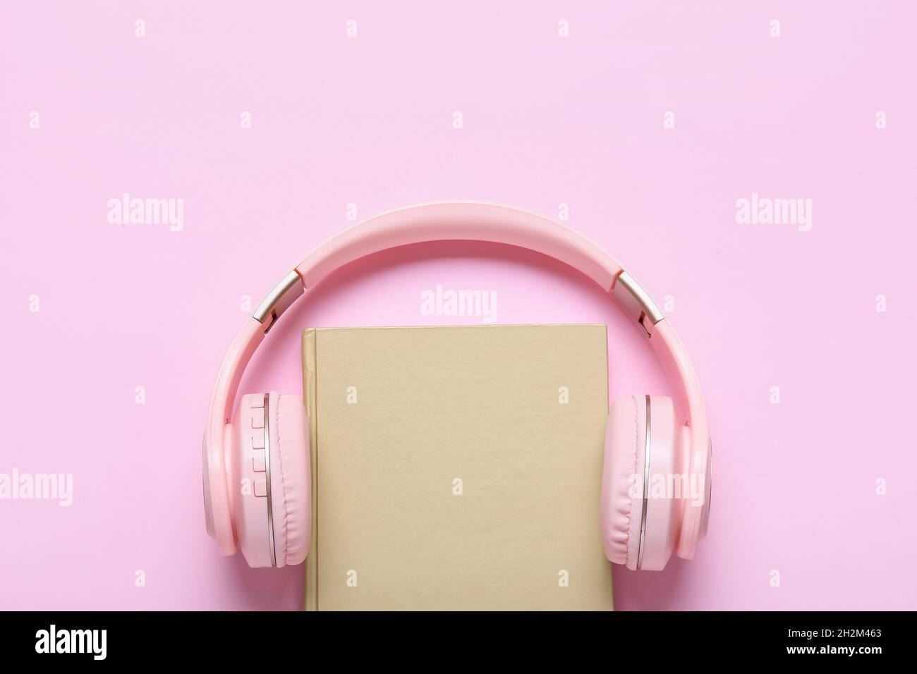 Modern headphones and book on color background Stock Photo - Alamy