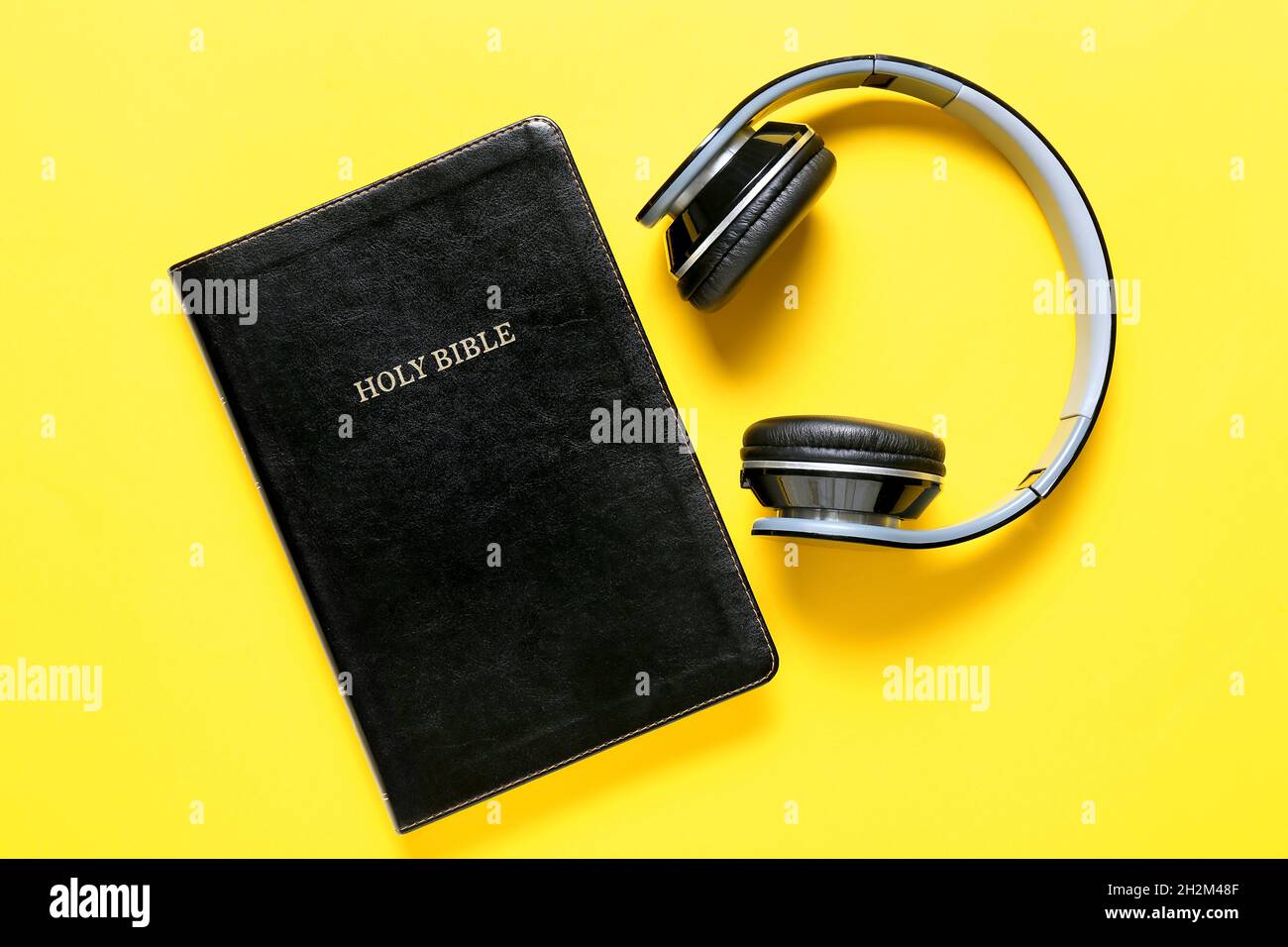 Holy Bible and modern headphones on color background Stock Photo - Alamy