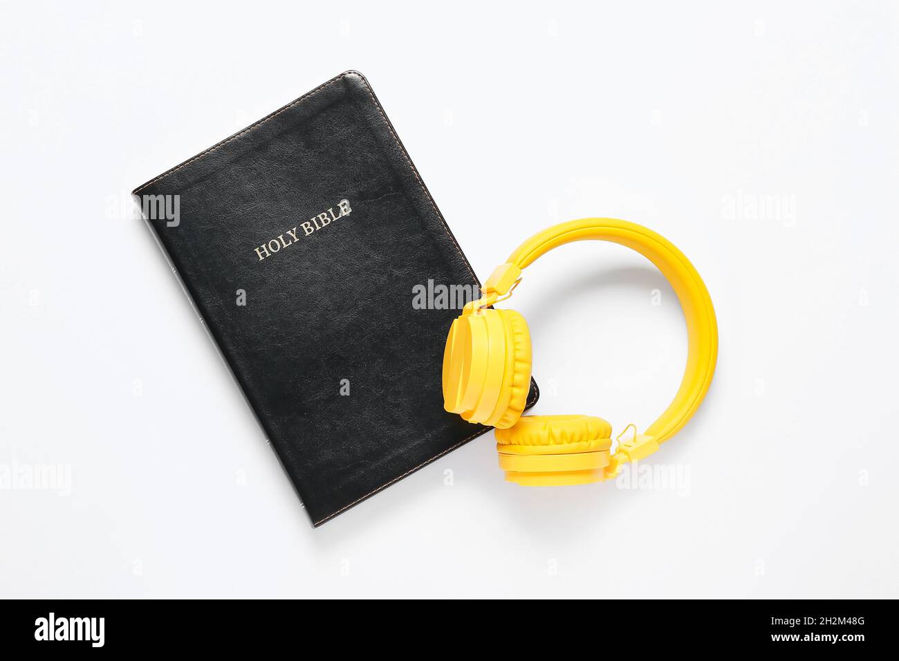 Holy Bible and modern headphones on white background Stock Photo - Alamy