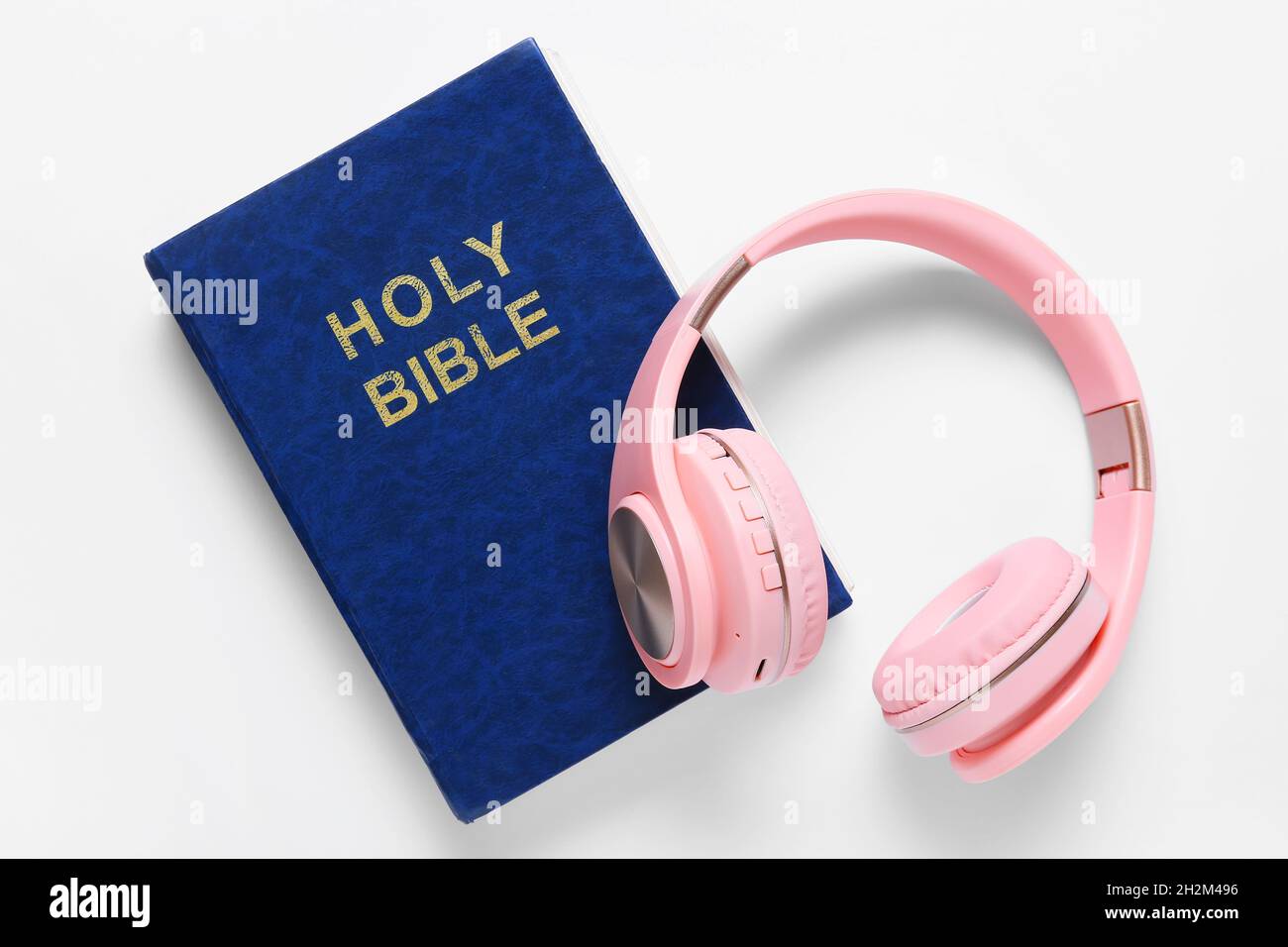 Holy Bible and modern headphones on white background Stock Photo - Alamy