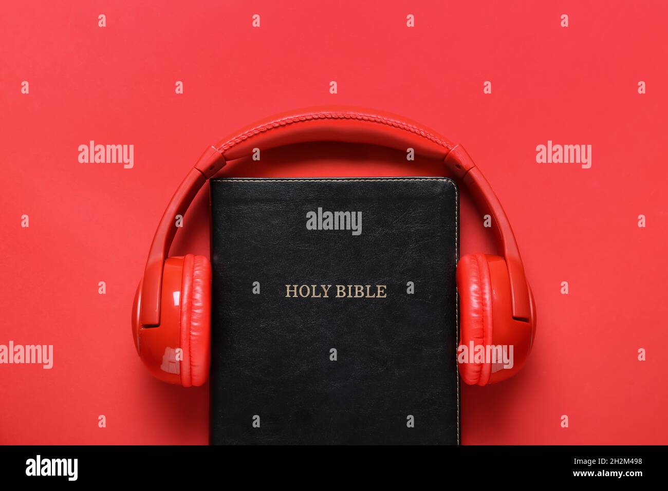 Holy Bible and modern headphones on color background Stock Photo - Alamy