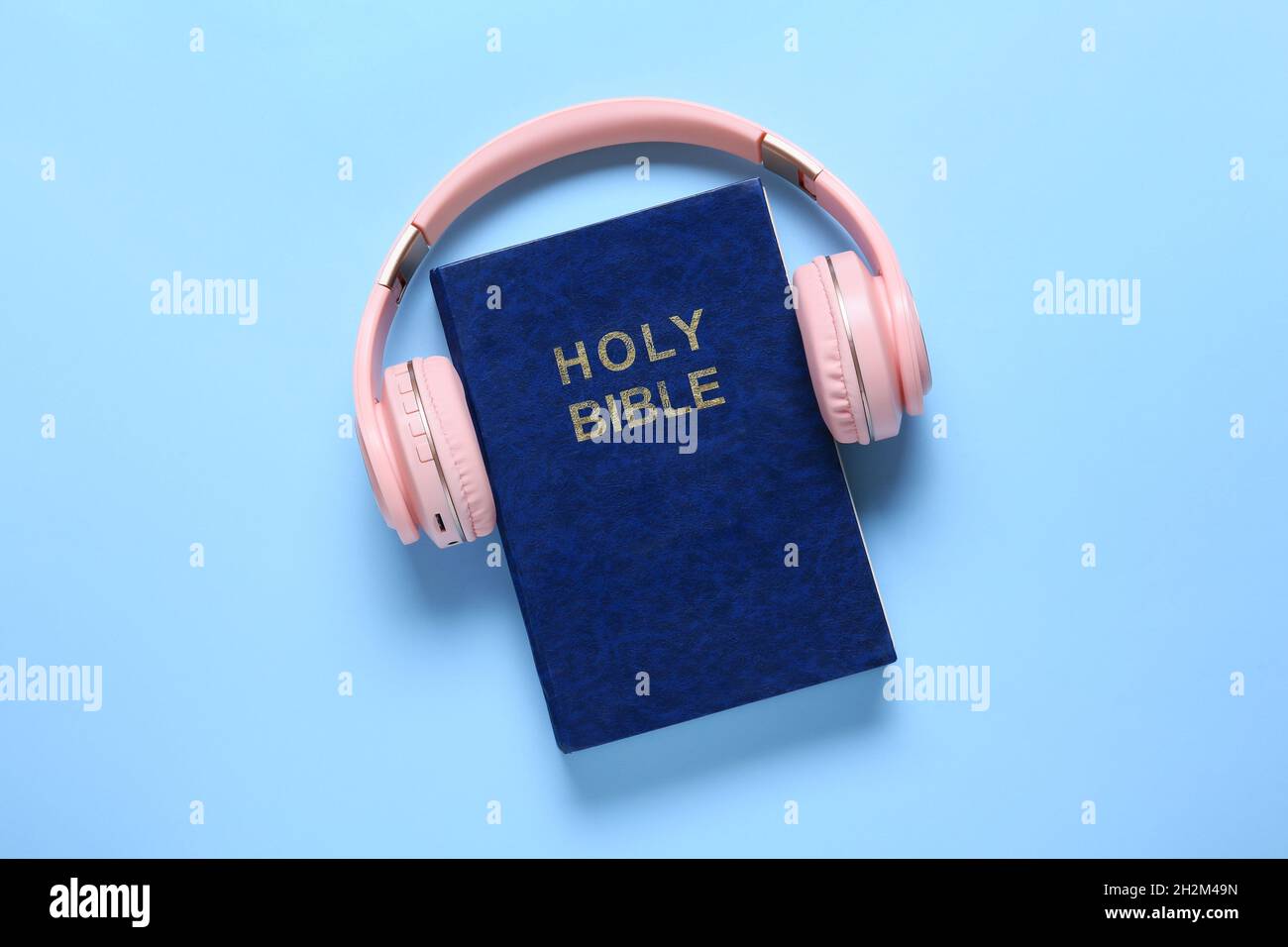 Holy Bible and modern headphones on color background Stock Photo - Alamy