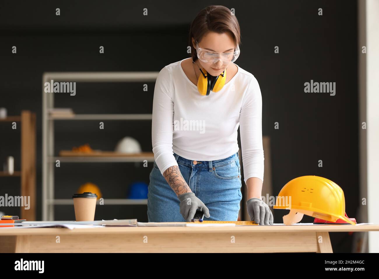 Female construction worker at table in office Stock Photo - Alamy