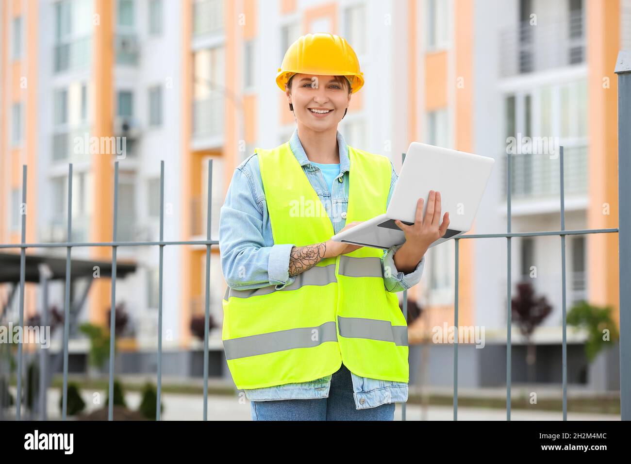Female construction worker using laptop outdoors Stock Photo - Alamy