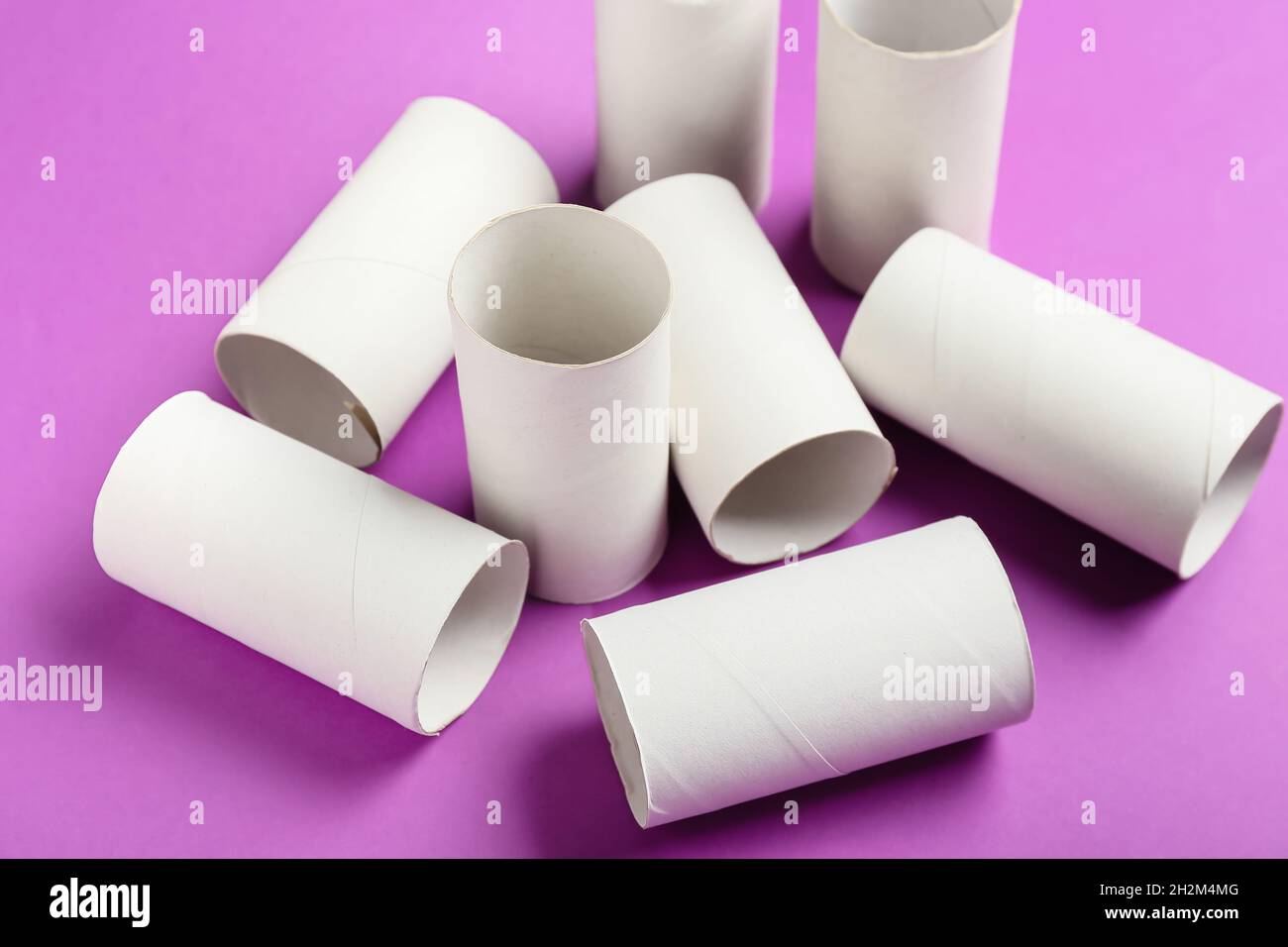 Toilet paper cardboard tubes on purple background, closeup Stock Photo ...