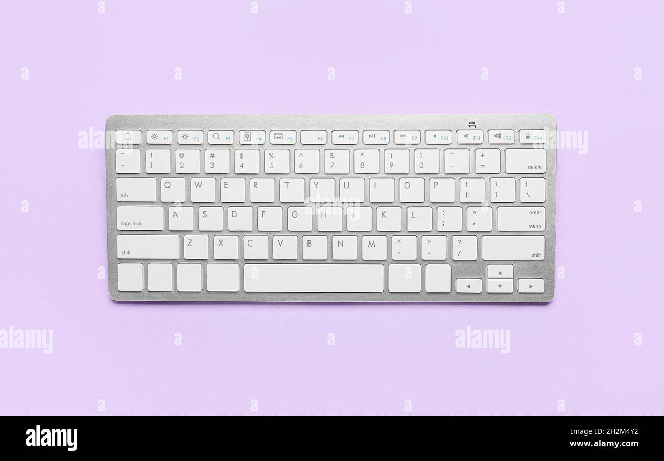 Modern computer keyboard on color background Stock Photo - Alamy