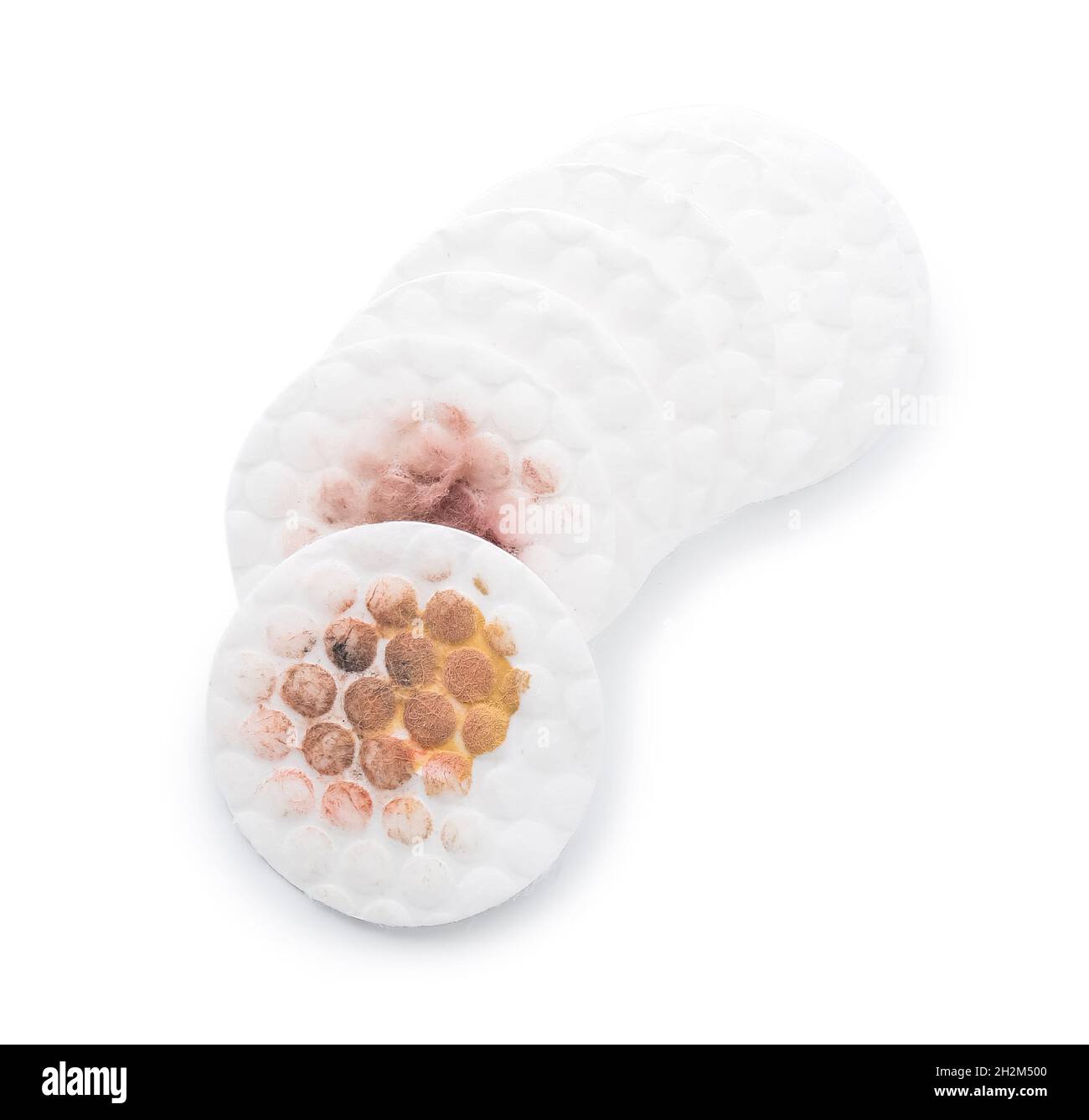 Used cotton pads on white background Stock Photo - Alamy