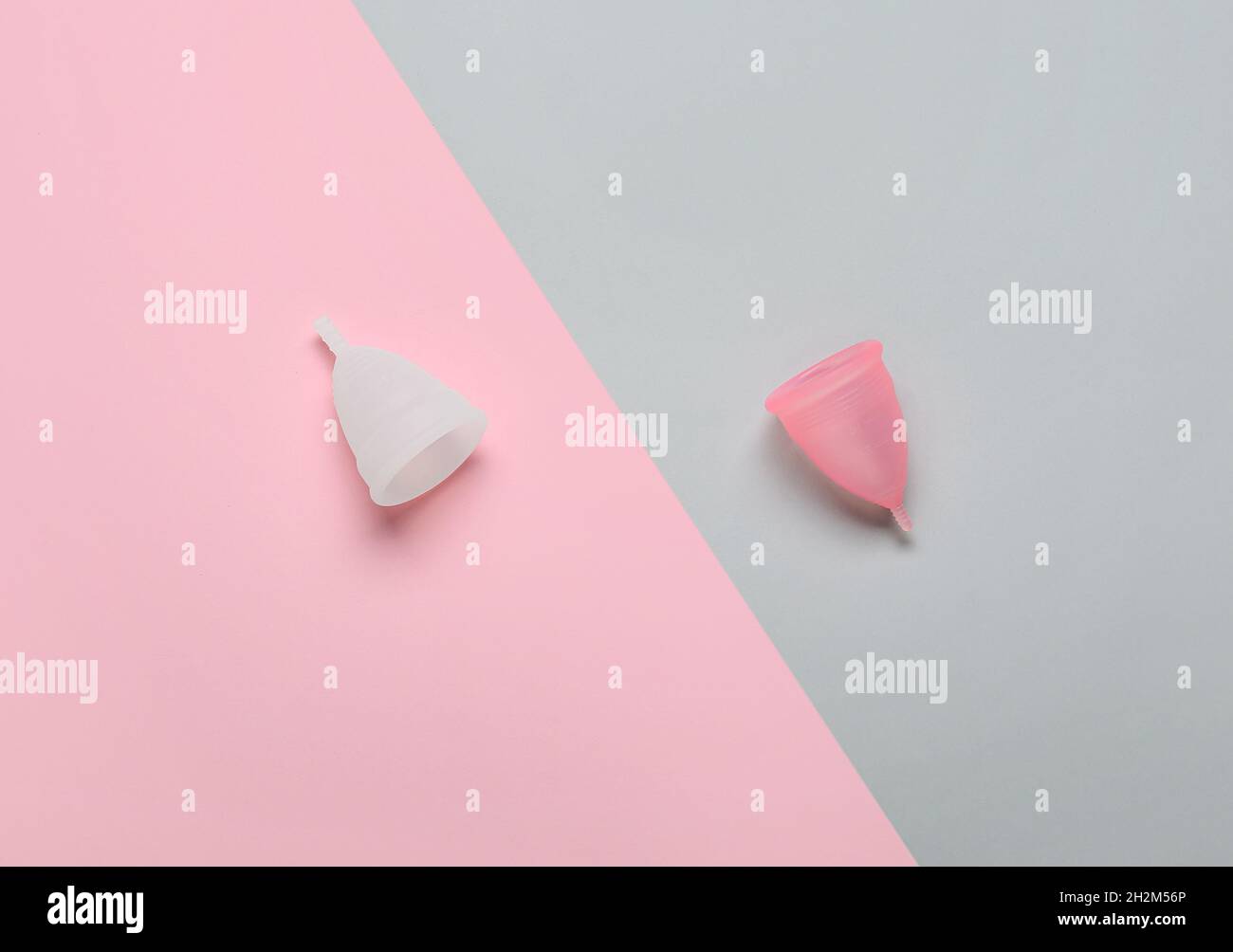 Menstrual cups on color background Stock Photo - Alamy