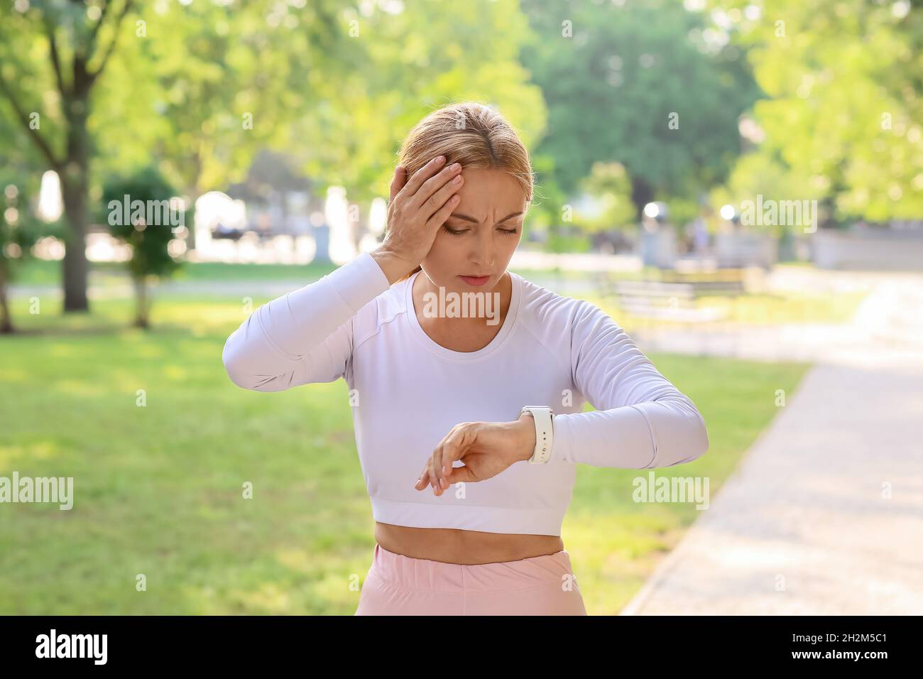 Portrait fitness woman checking pulse hi-res stock photography and ...