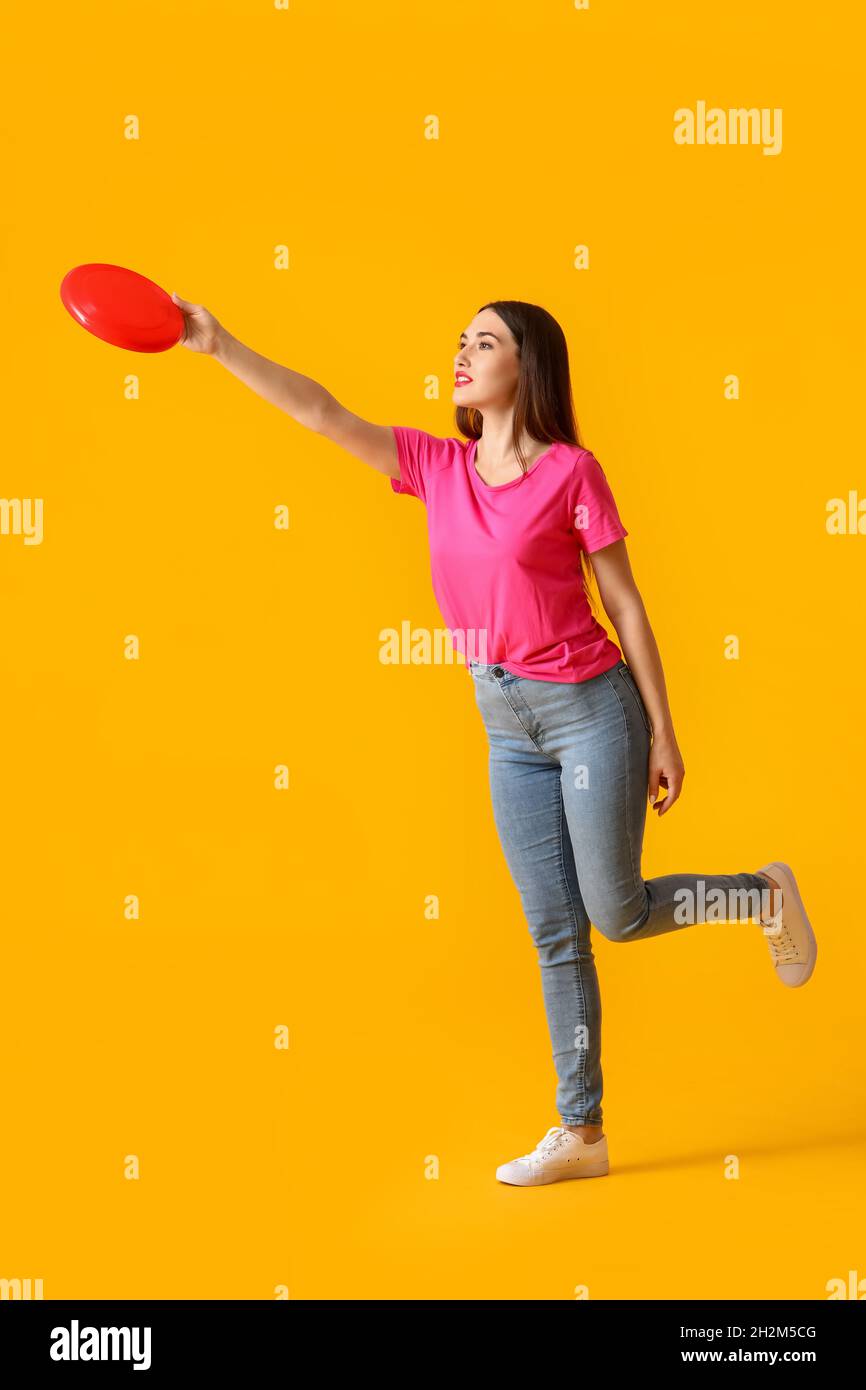 Beautiful young woman playing frisbee on color background Stock Photo ...
