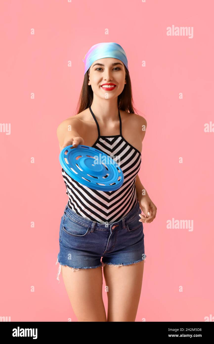 Beautiful young woman playing frisbee on color background Stock Photo ...