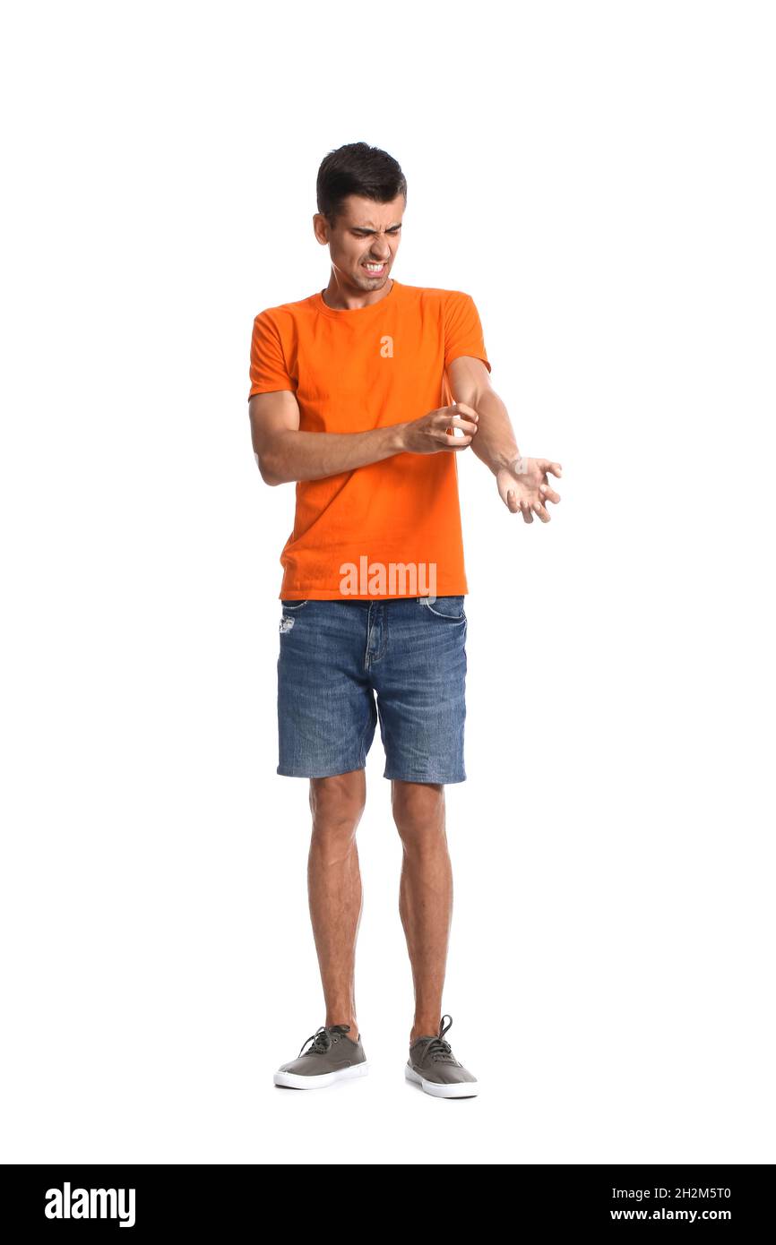 Young man scratching himself on white background Stock Photo - Alamy