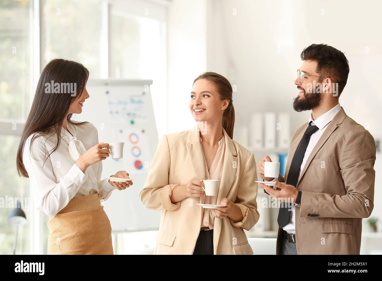 Business people having coffee break in office Stock Photo - Alamy