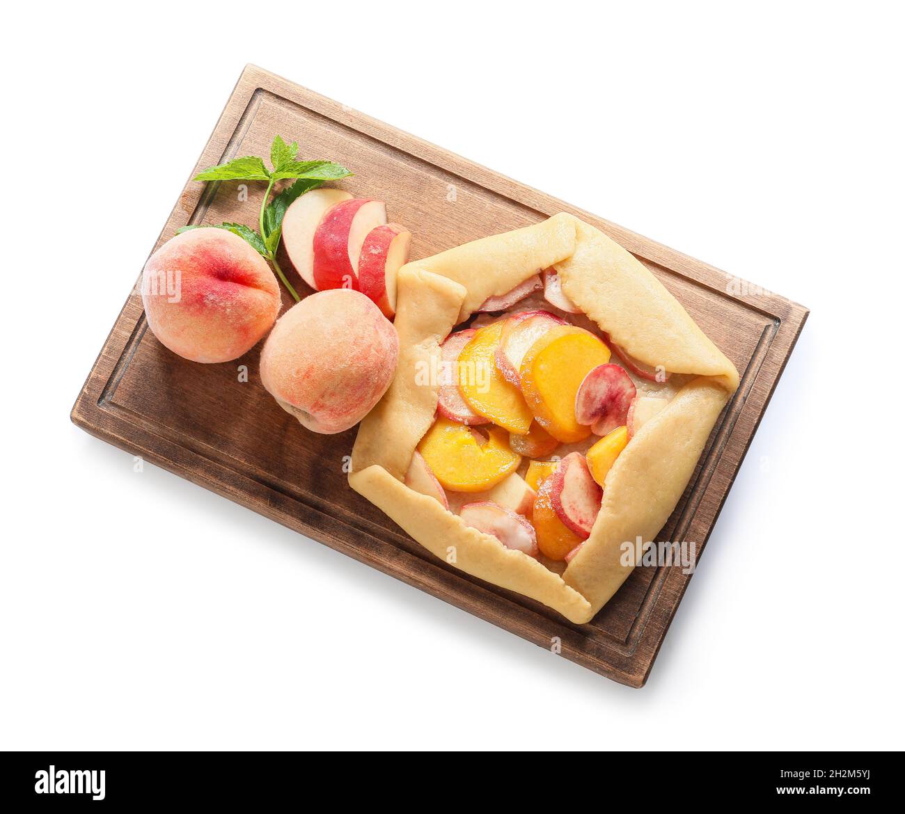 Wooden board with raw peach galette on white background Stock Photo - Alamy