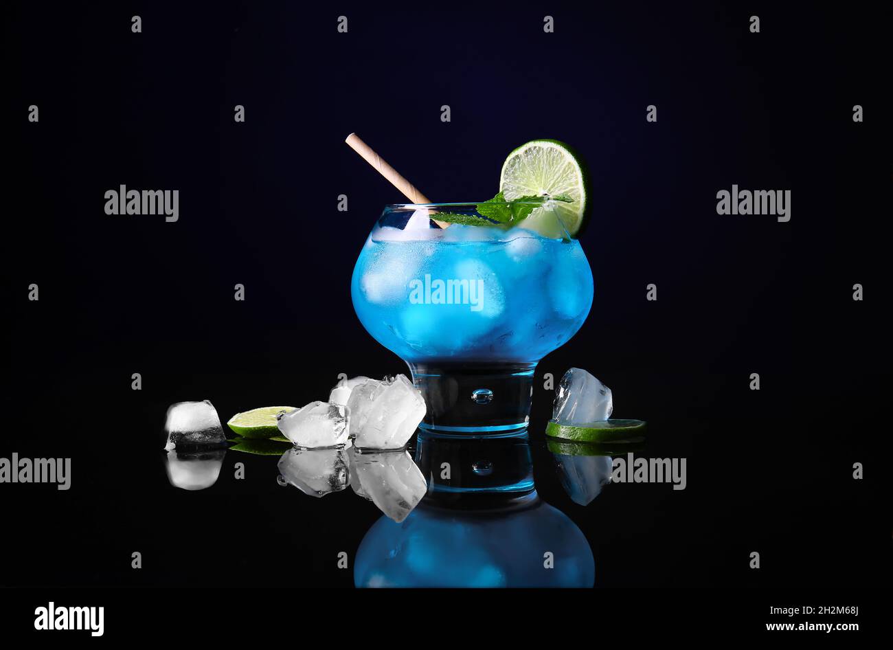Glass of Blue Lagoon cocktail on dark background Stock Photo - Alamy