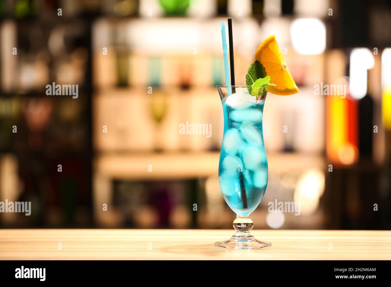 Glass of Blue Lagoon cocktail on table in bar Stock Photo - Alamy