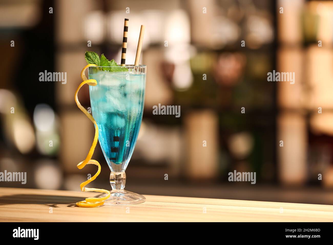 Glass of Blue Lagoon cocktail on table in bar Stock Photo - Alamy
