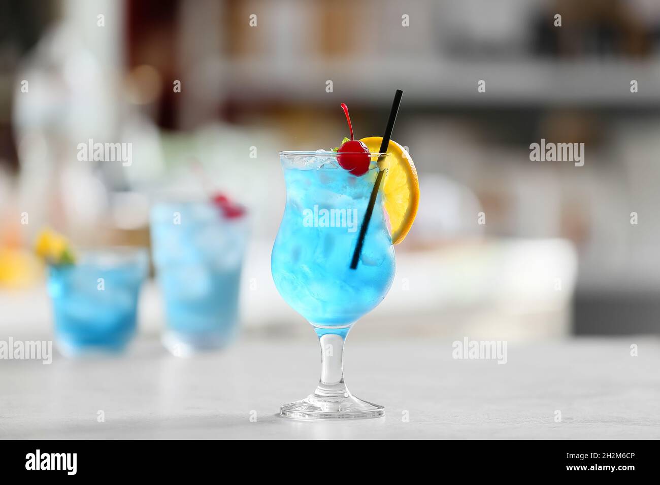 Glasses of Blue Lagoon cocktail on table in room Stock Photo - Alamy