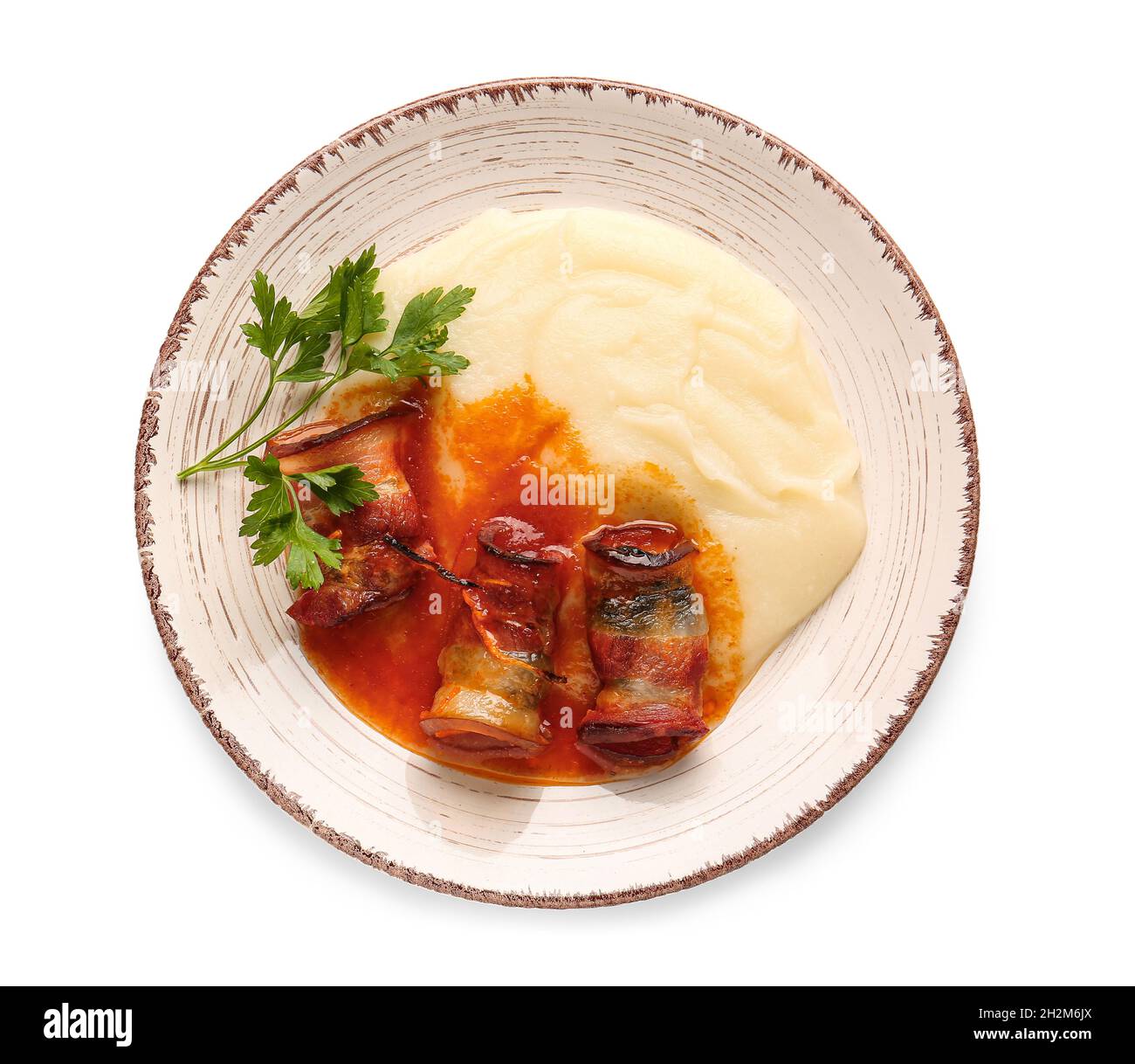 Plate with mashed potatoes, delicious prunes baked in bacon and gravy ...