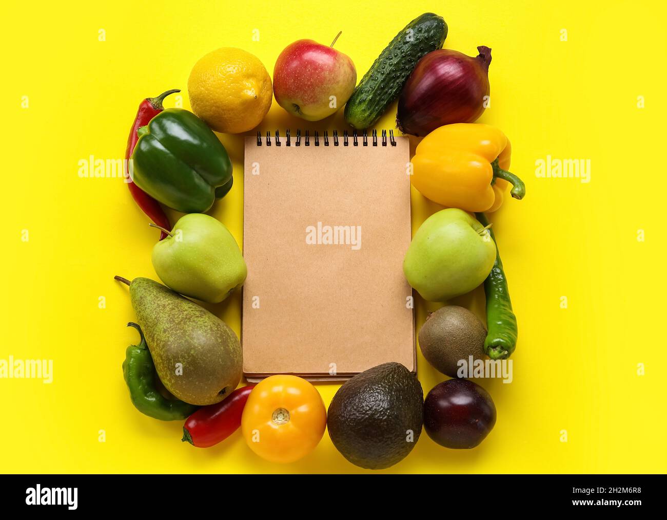 Blank notebook, fruits and vegetables on color background. Vegan Day ...