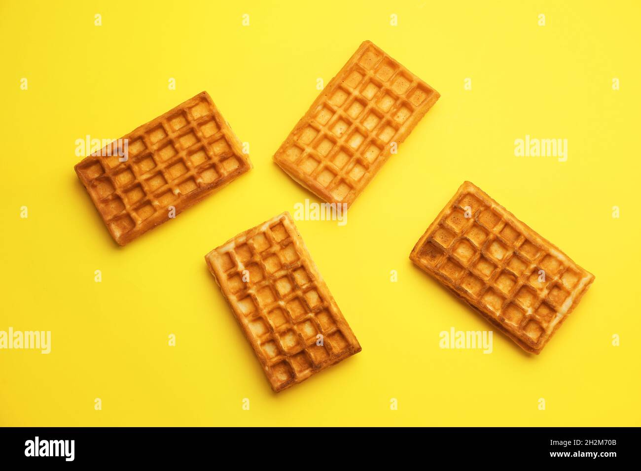 Delicious Belgian waffles on yellow background Stock Photo - Alamy