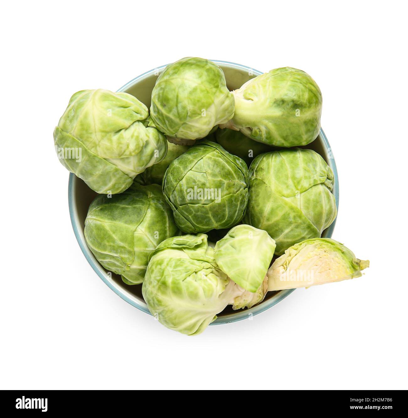 Raw Brussels cabbage in bowl on white background Stock Photo - Alamy