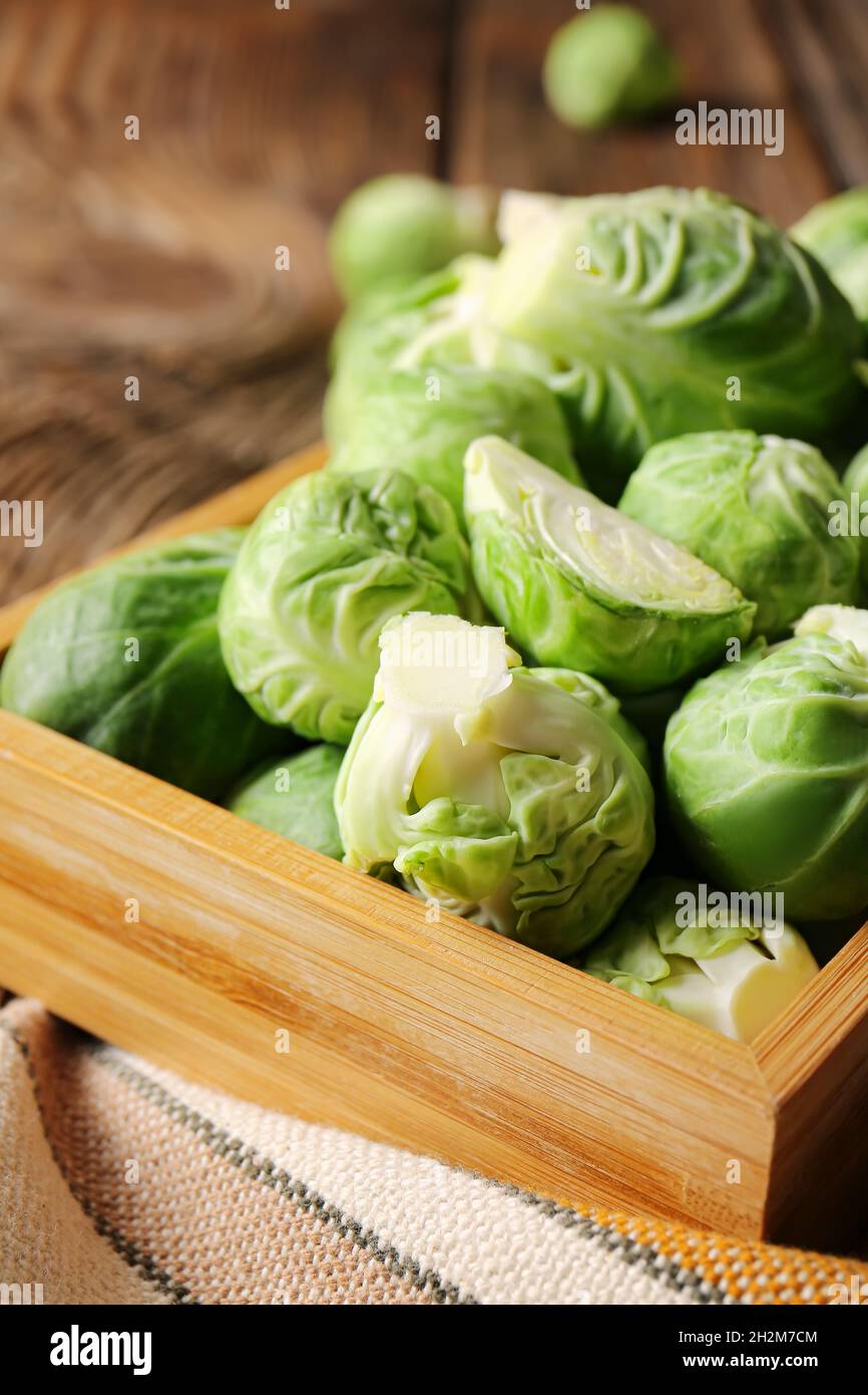 Wooden box with raw Brussels cabbage on table, closeup Stock Photo - Alamy